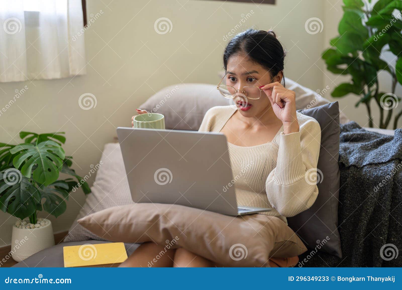 Stunned Woman Is Looking At Her Laptop Screen With A Shocked Face