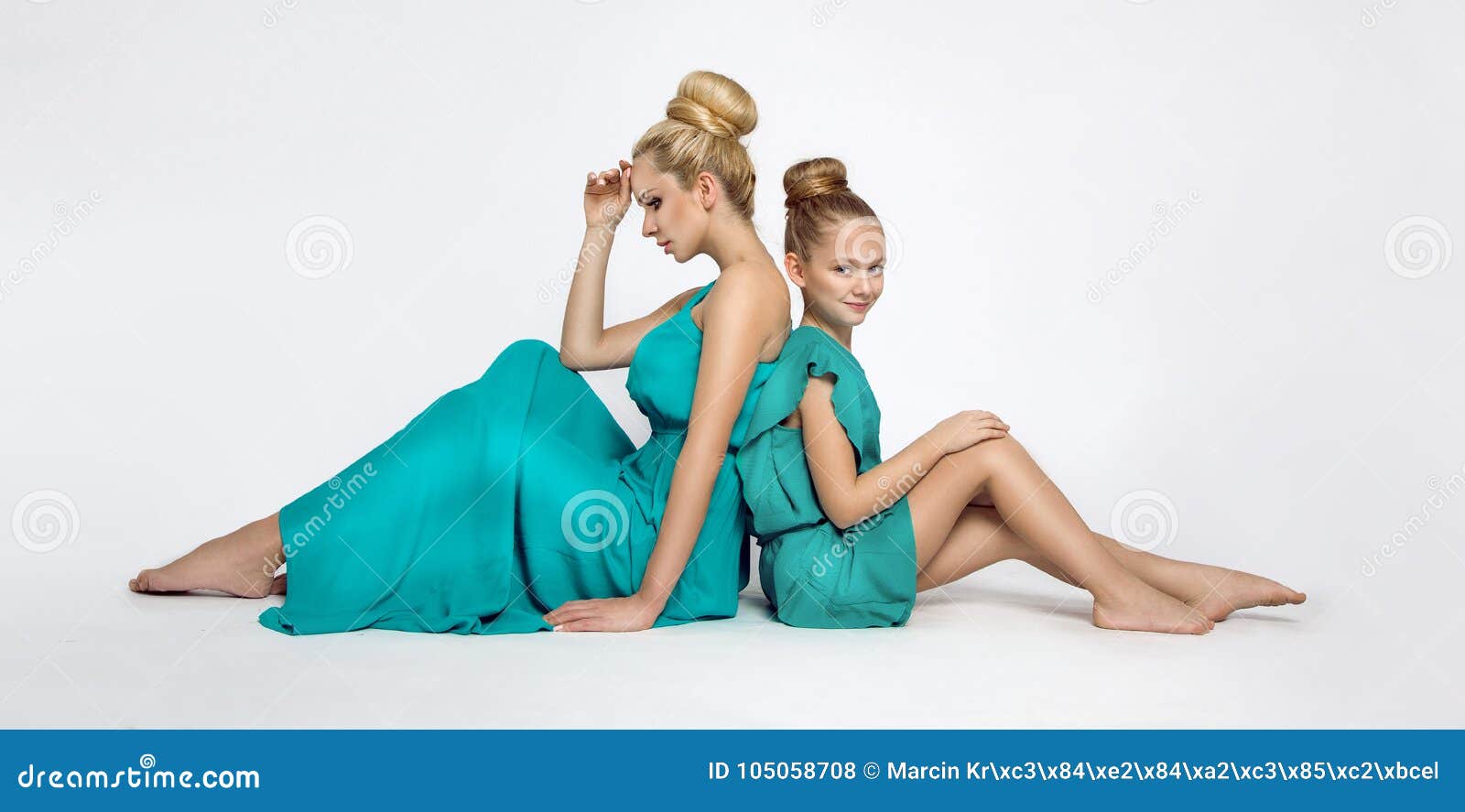 Stunning Beauty A Young Mother With A Cute Blonde Daughter Sitting On A