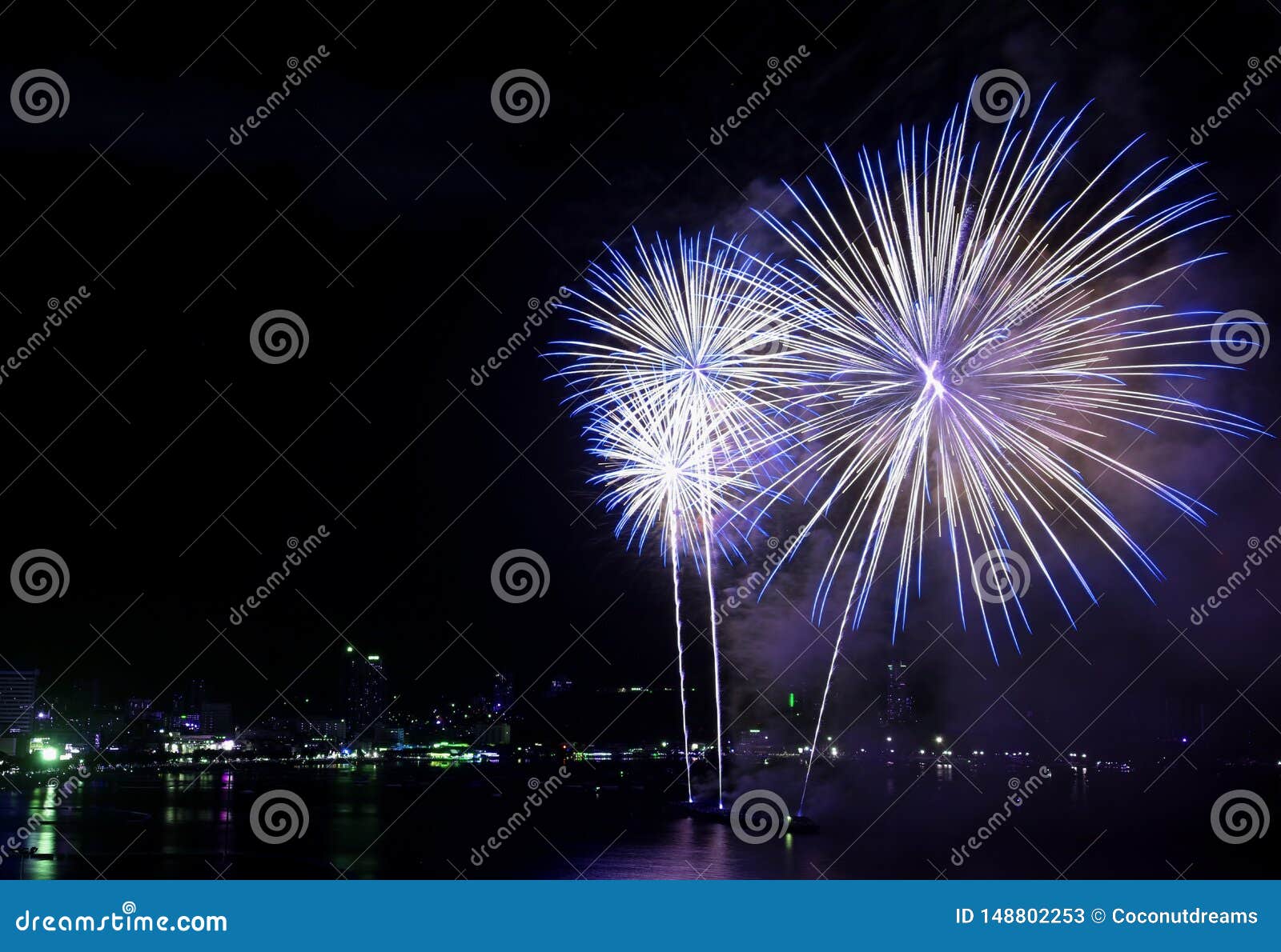 Stunning Blue and White Fireworks Exploding into the Night Sky Over the ...