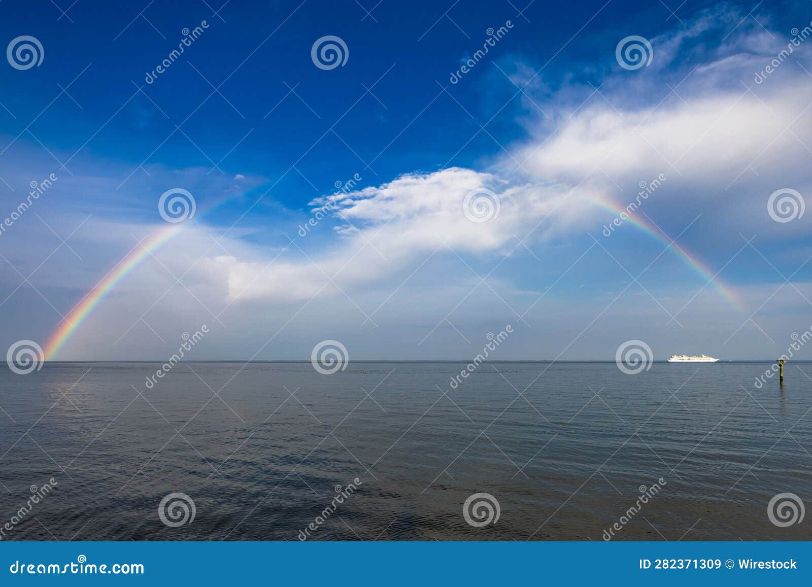 Stunning Boat Sailing in Front of a Beautiful Rainbow Arching Over the ...