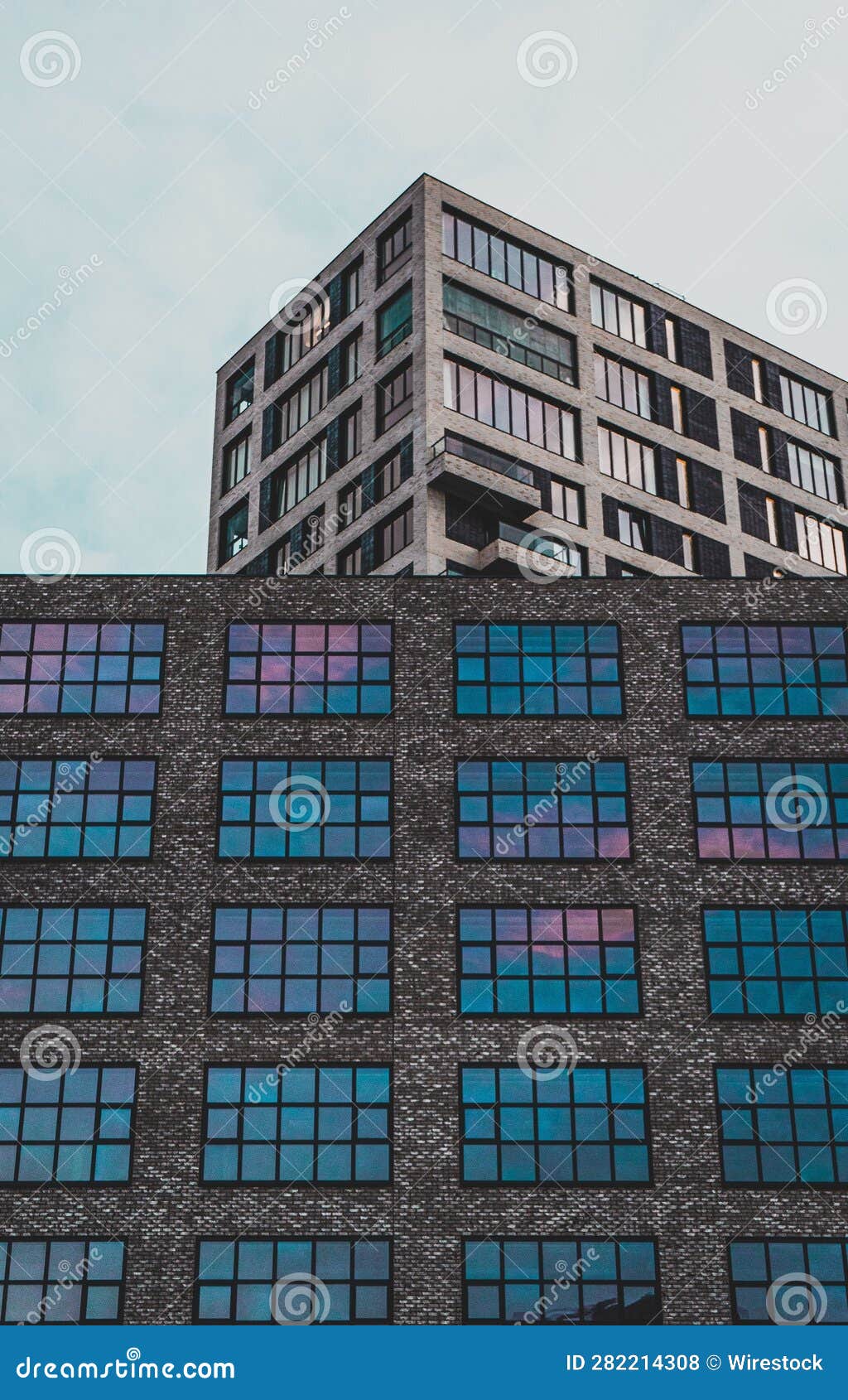 Large Brick Building with Multiple Windows on the Background of Another ...