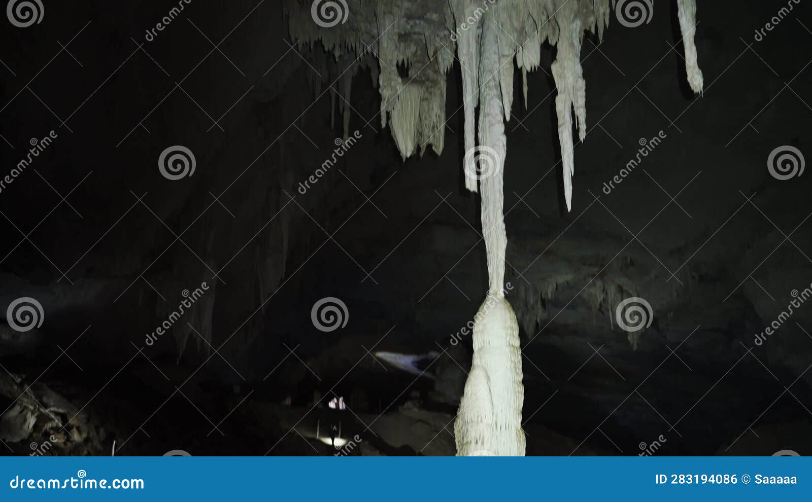 Stunning Illuminated Stalactite Lamp in Underground Cave Exploration ...