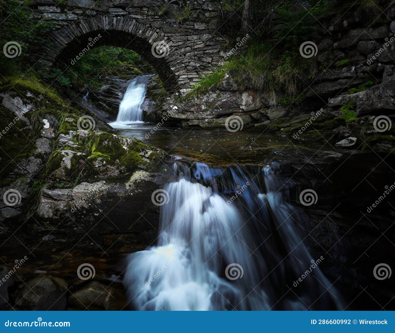 Stunning Landscape Featuring a Bridge Crossing a Cascading Waterfall ...