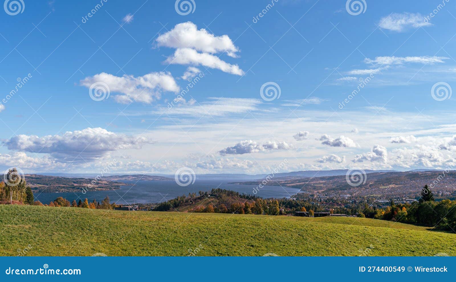 Stunning Landscape Featuring a Wide Open Field and a Tranquil Lake in ...