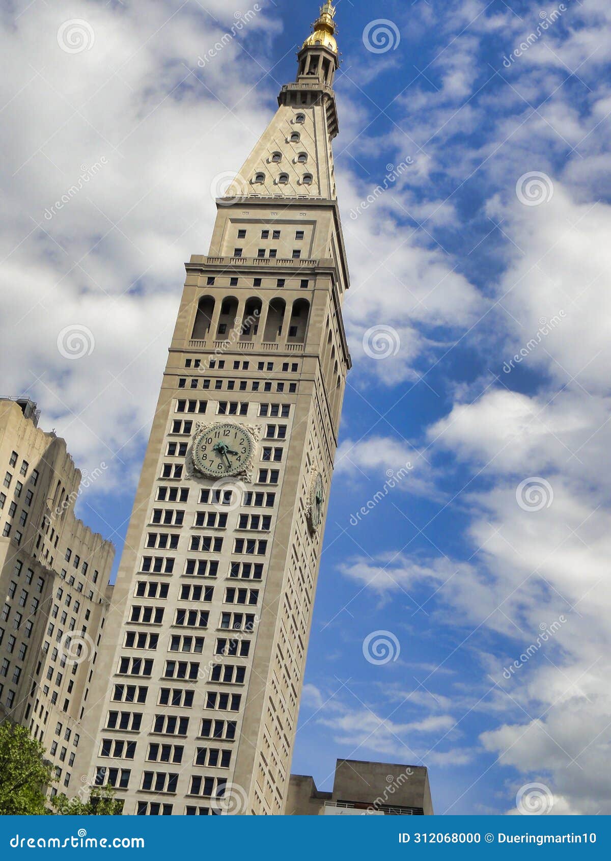 A Skyscraper with a Clock Tower Atop, Piercing the Blue Sky New York ...