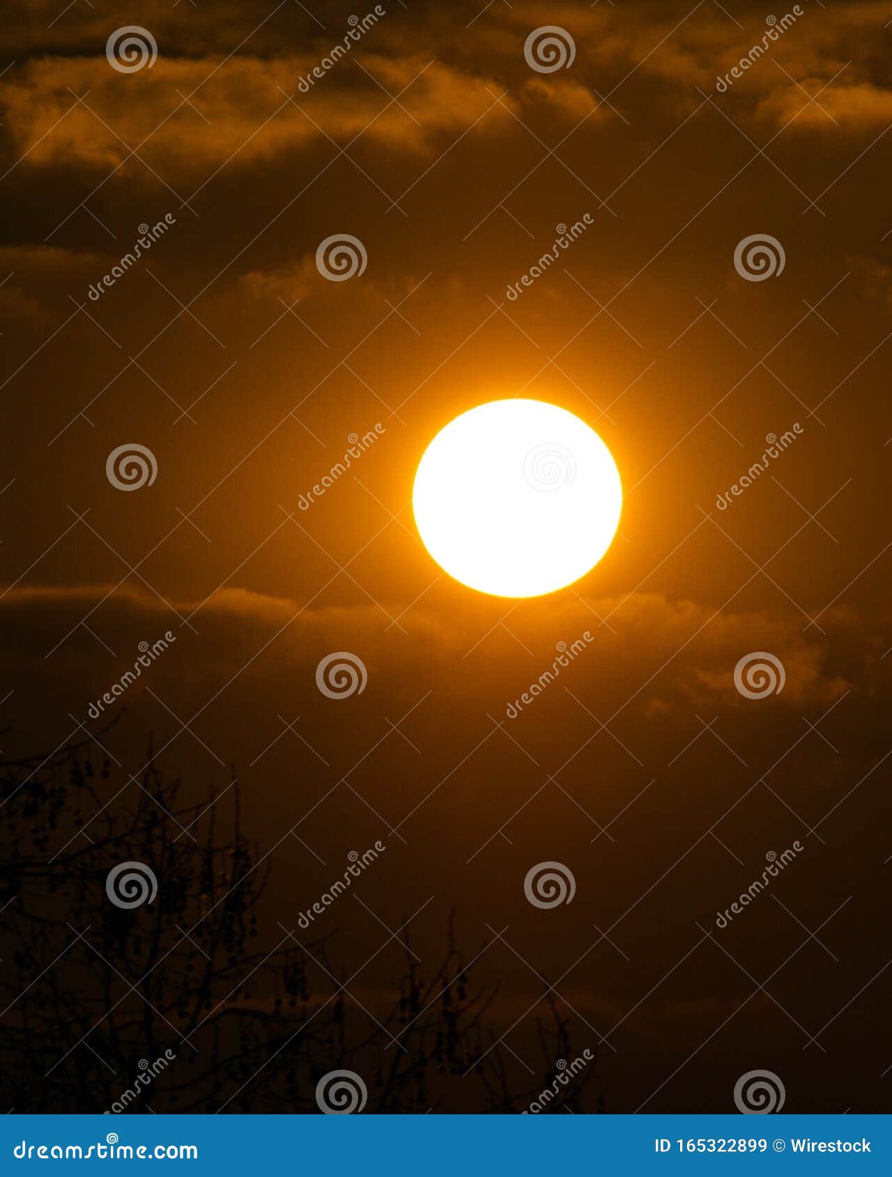 Stunning Vertical Shot of the Bright Sun at Sunset Above the Beautiful ...