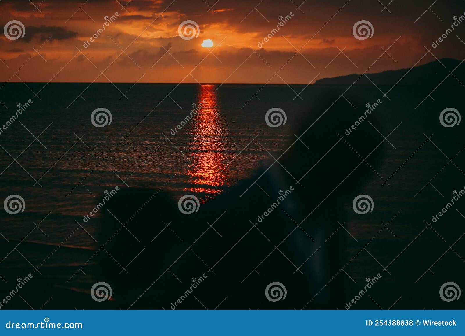 Stunning View of a Dark Red Sunset Over the Water Stock Photo - Image ...