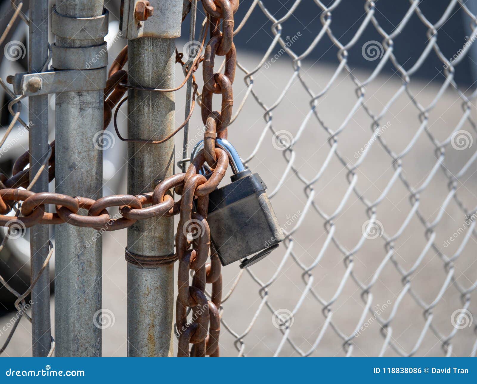 Sturdy Chain Wraps a Chain Link Fence, Closed with a Padlock Stock ...