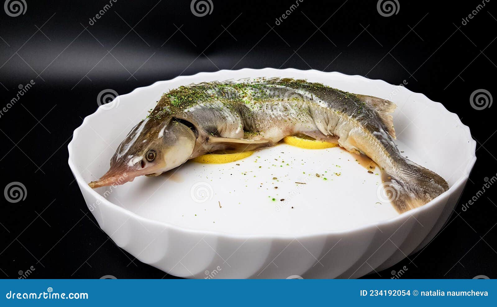 Sturgeon Fish on a White Plate on a Black Background. Cooking Expensive ...