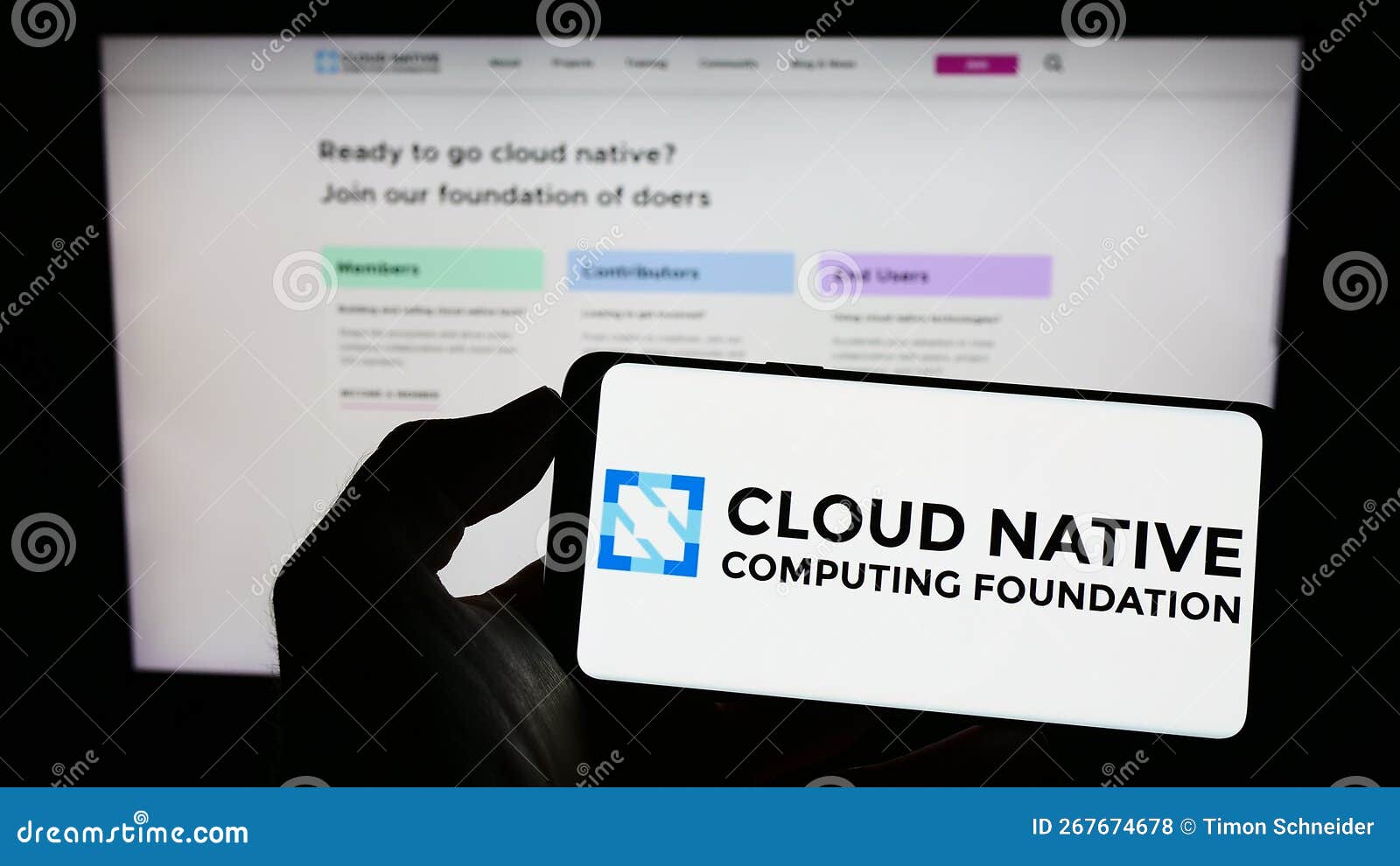 Person Holding Cellphone with Logo of Cloud Native Computing Foundation (CNCF) on Screen in ...