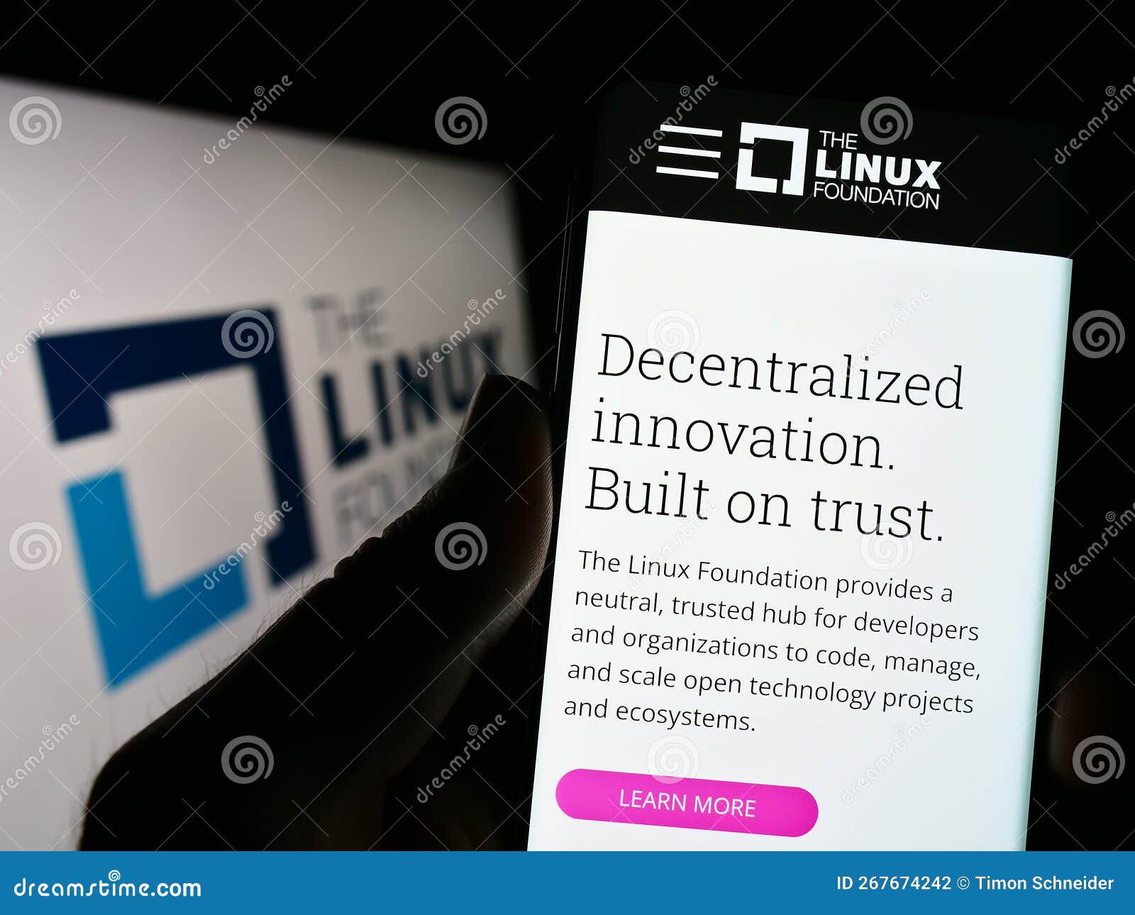 Person Holding Cellphone with Website of Technology Consortium Linux ...