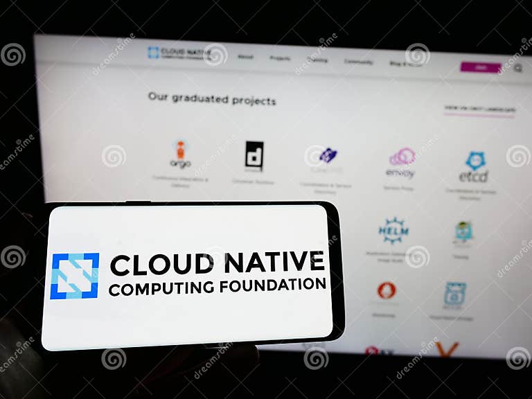 Person Holding Mobile Phone with Logo of Cloud Native Computing Foundation (CNCF) on Screen in ...