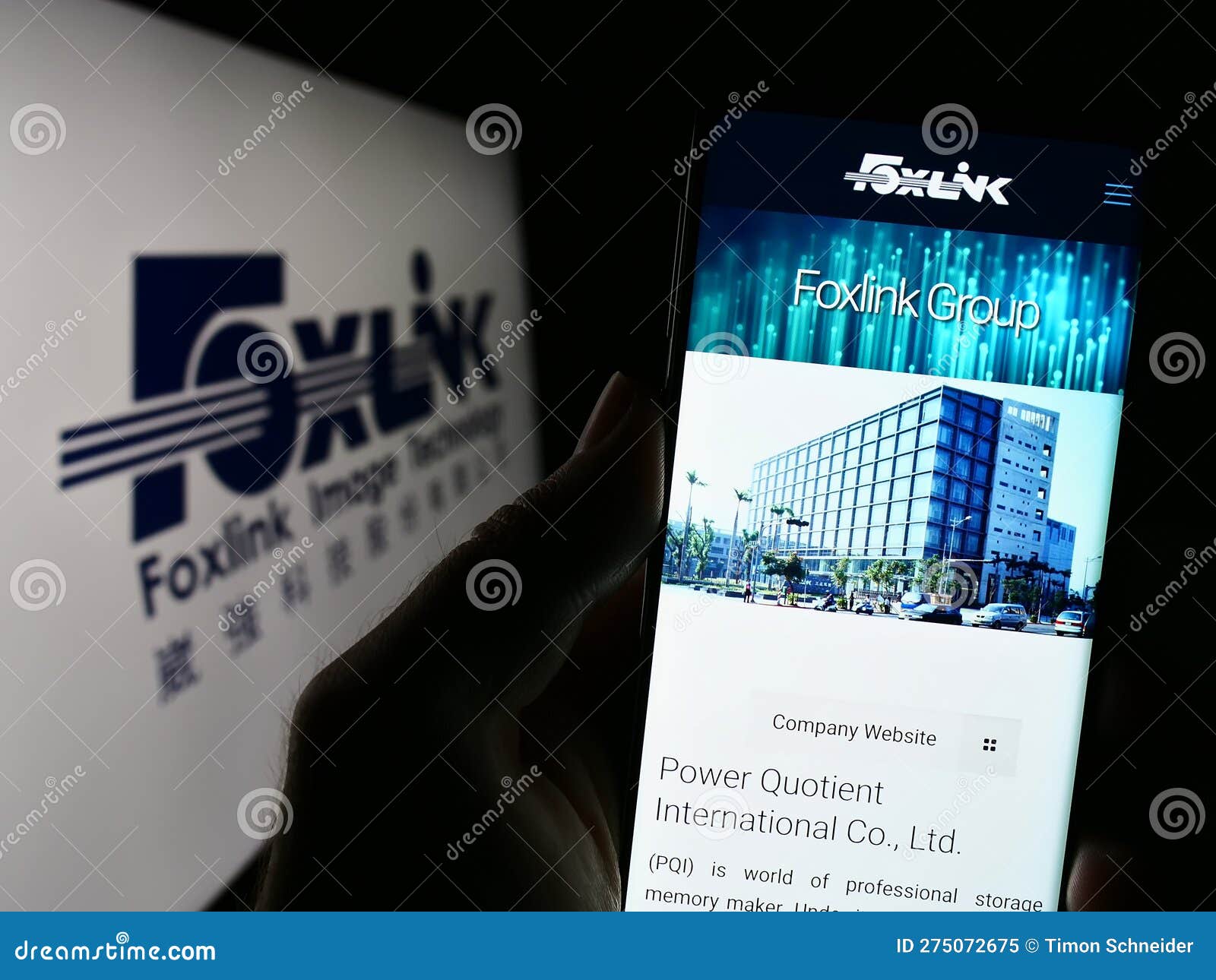 Person Holding Smartphone with Webpage of Company Foxlink Image Technology Co. Ltd. on Screen in ...