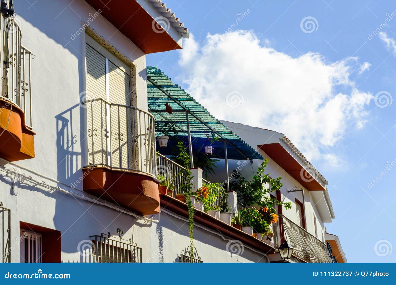 Stylish Balcony with a Metal Railing, Solid Architectural Element, a ...