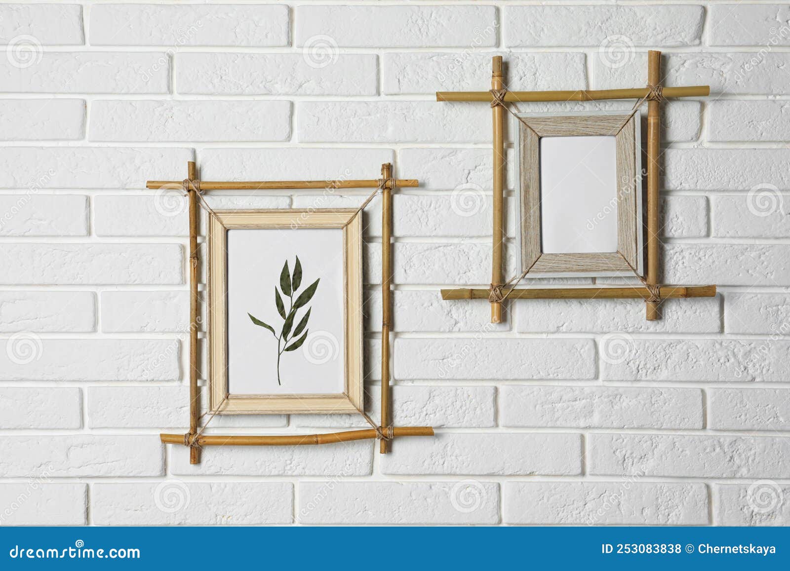 Stylish Bamboo Frames Hanging on Brick Wall Stock Photo - Image of ...