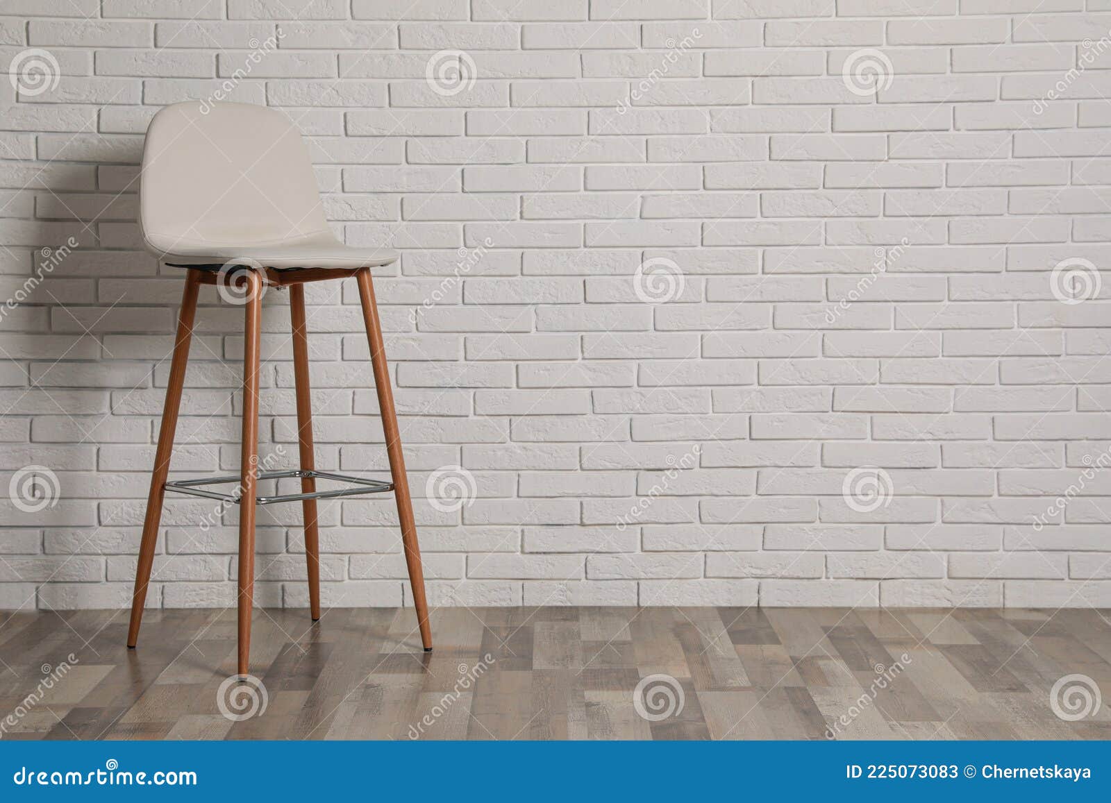 Stylish Bar Stool Near White Brick Wall. Space for Text Stock Image ...