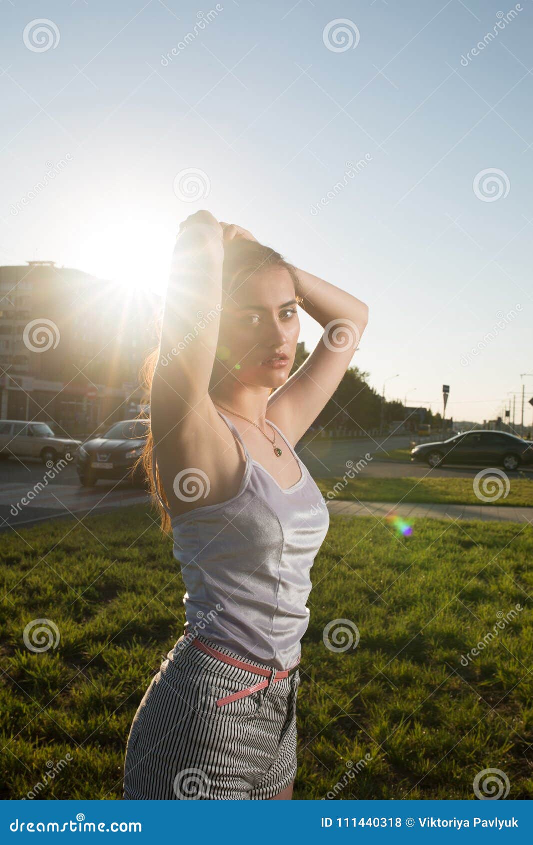 Stylish Brunette Young Model Posing in Rays of Sun at Sunset in Stock ...