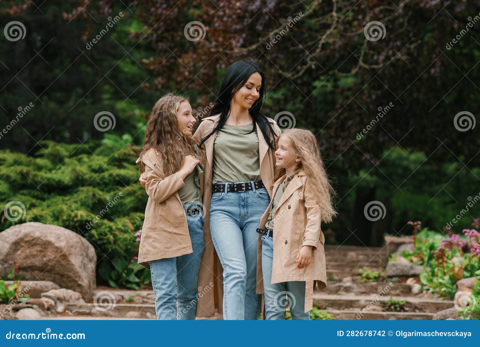 Stylish Caucasian Mom And Her Two Daughters Are Chatting And Walking