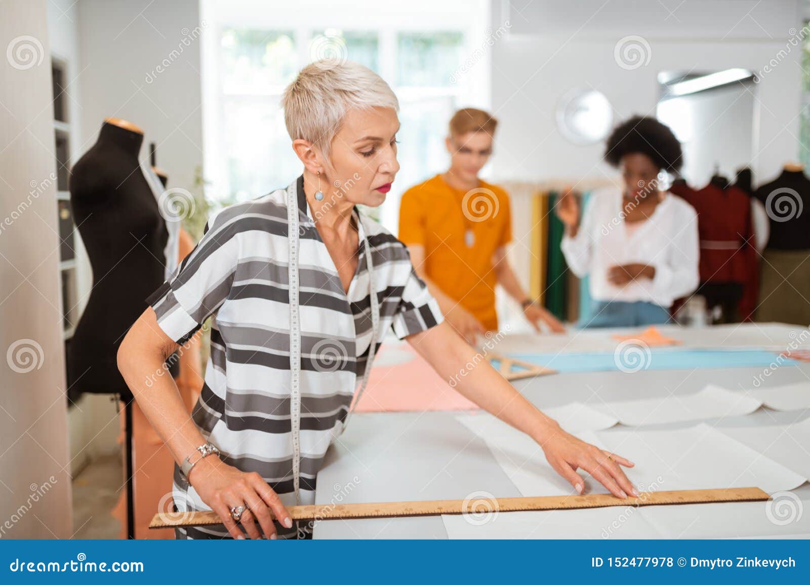 Stylish Caucasian Woman Tailor Standing in a Studio Stock Photo - Image ...