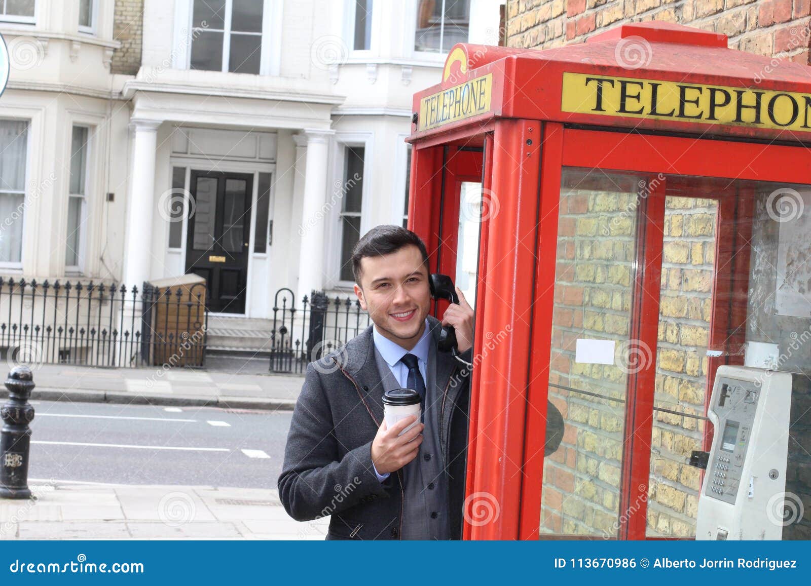Stylish Ethnic Gentleman Calling from Vintage Payphone Stock Photo ...