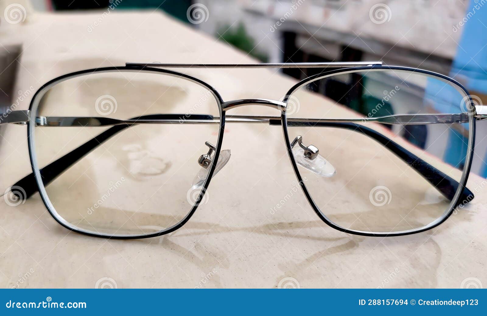 Stylish Eye Glasses in Metal Frame on Balcony Wall Stock Photo - Image ...