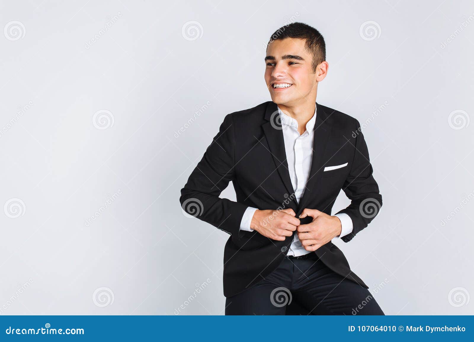 Stylish Guy Buttoning a Button in Studio Stock Photo - Image of hand ...