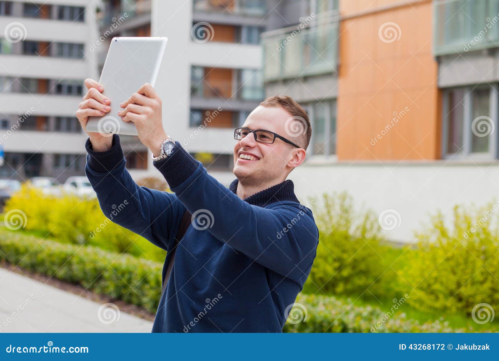 Stylish Guy Connected on Internet with Tablet in Town. he is Hap Stock ...