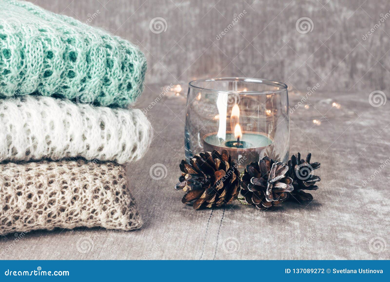 Stylish Knitted Pastel Colored Sweaters Folded in Stack with Pine Cones ...