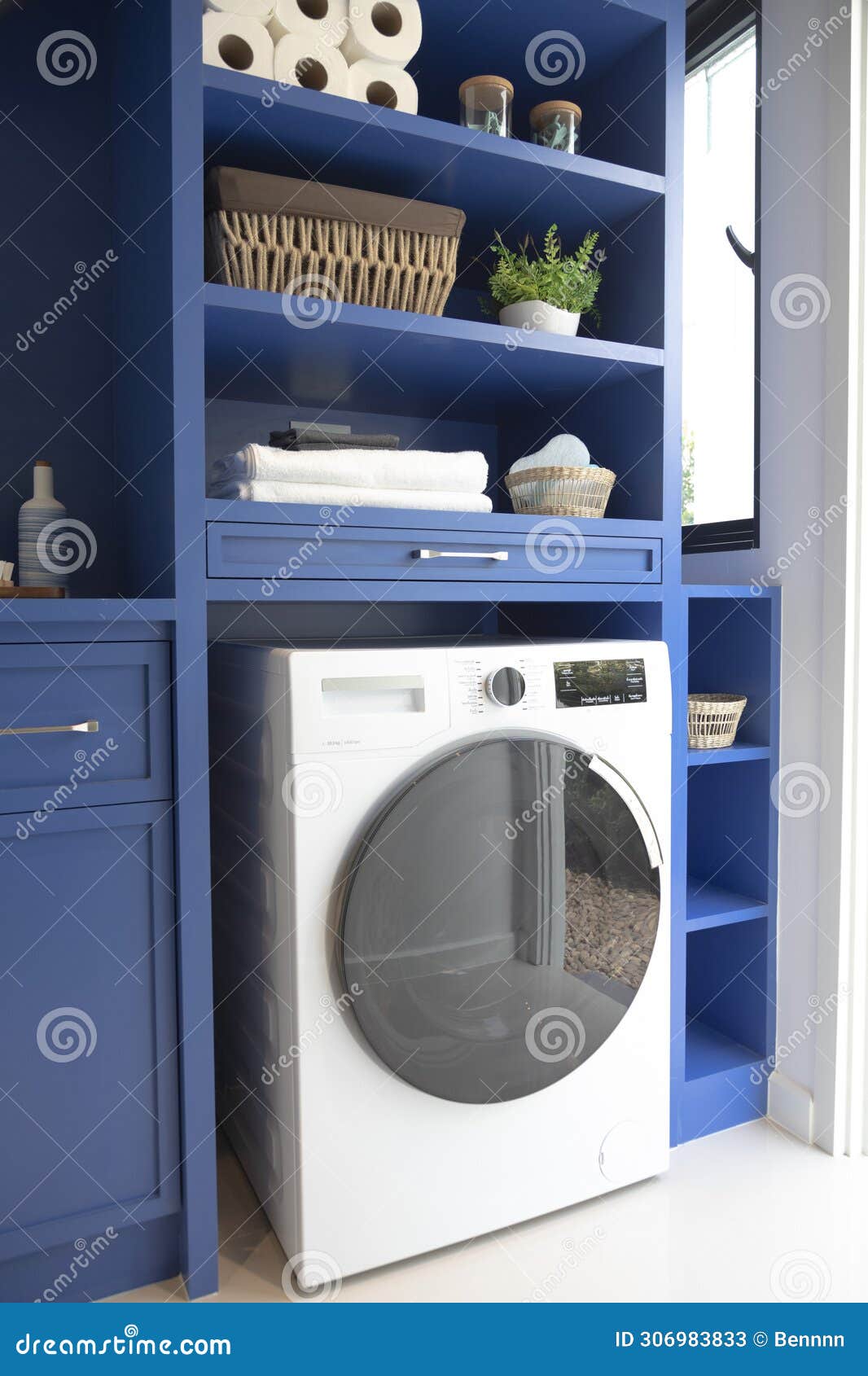 Stylish Laundry Room with Washing Machine and Blue Cabinet. Stock Image ...