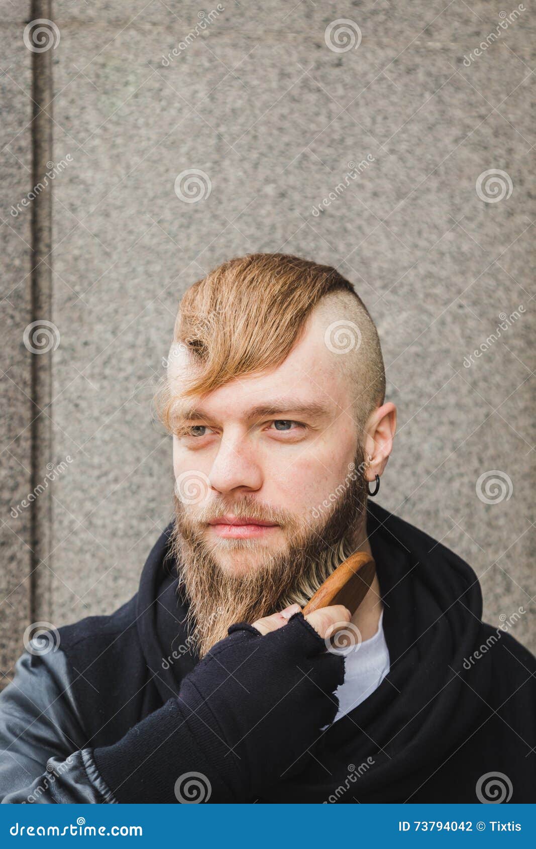 Stylish Man Brushing His Beard Stock Photo - Image of goth, beard: 73794042
