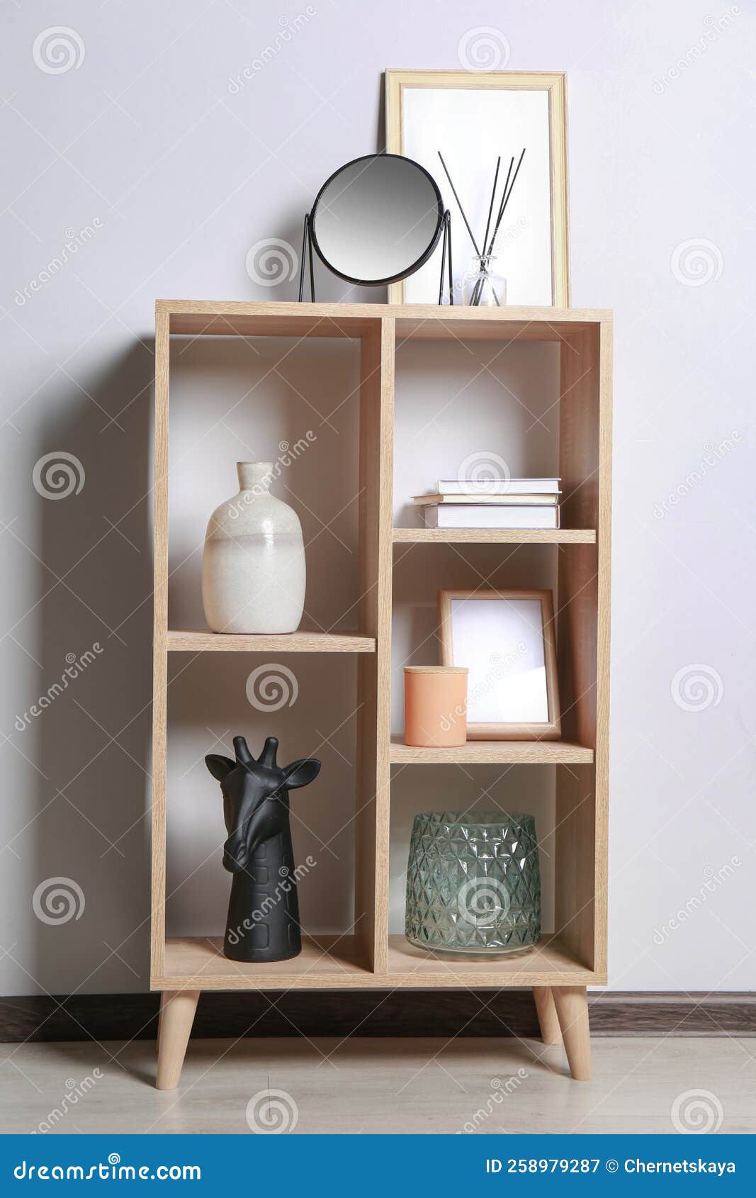 Stylish Mirror, Reed Diffuser and Picture Frame on Shelf Near Light ...