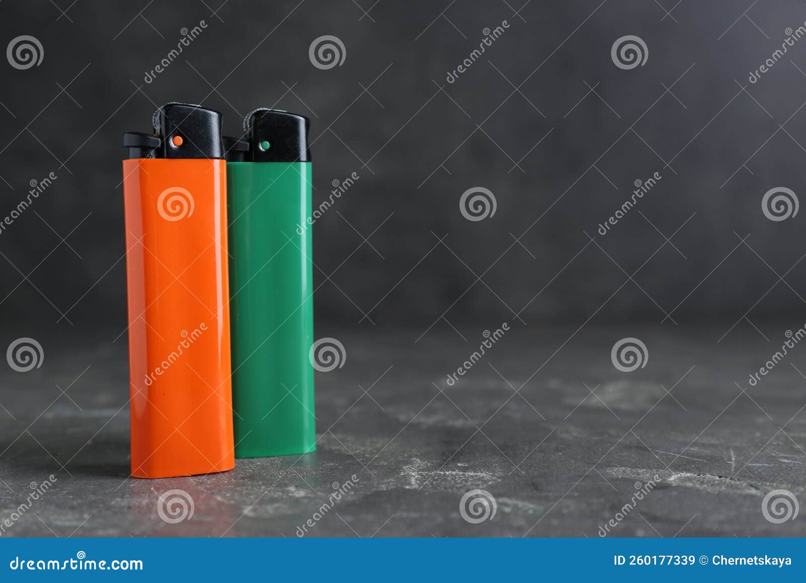 Stylish Small Pocket Lighters on Grey Table, Space for Text Stock Image ...
