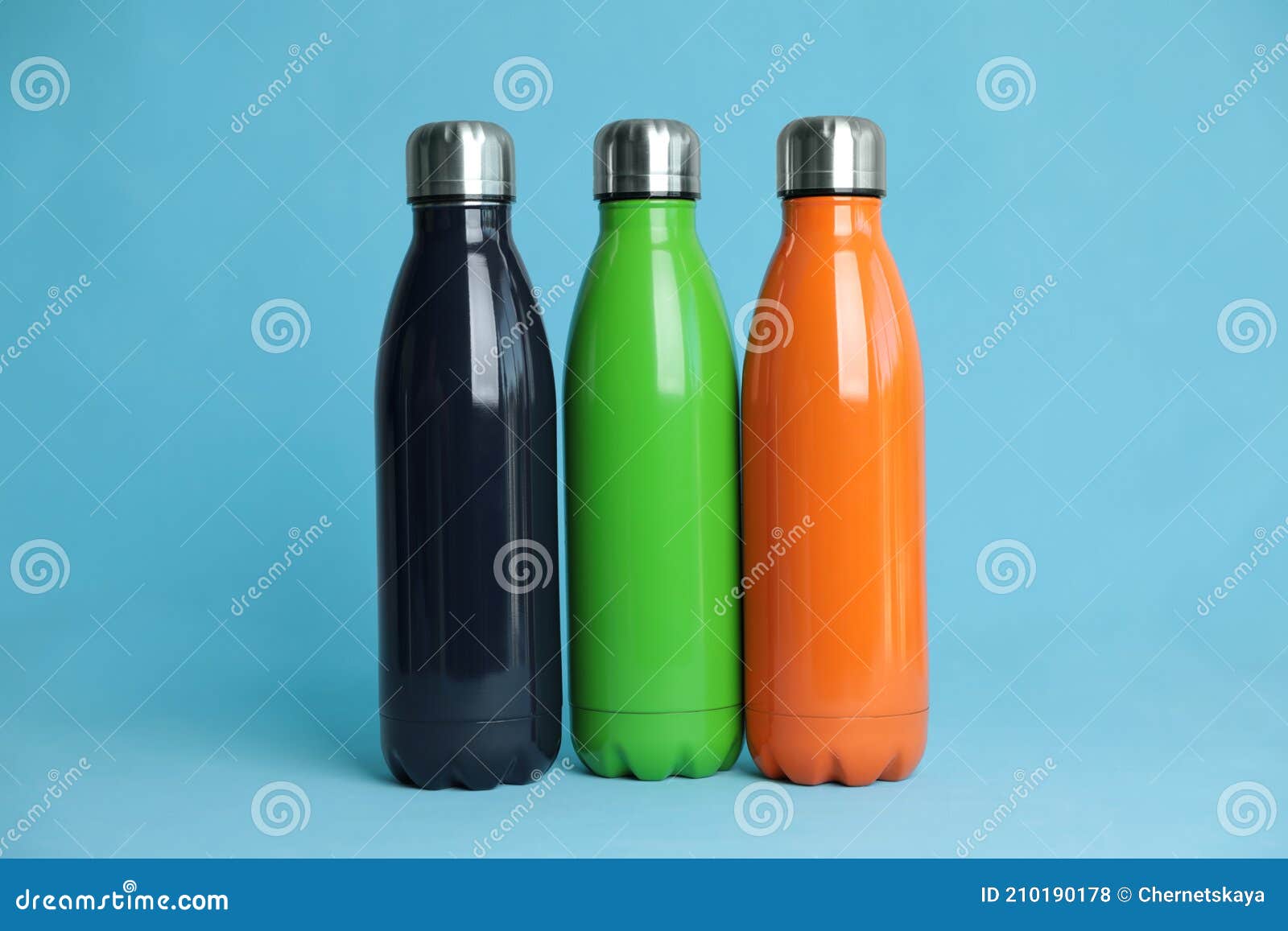 Stylish Stainless Thermo Bottles on Light Blue Background Stock Photo ...