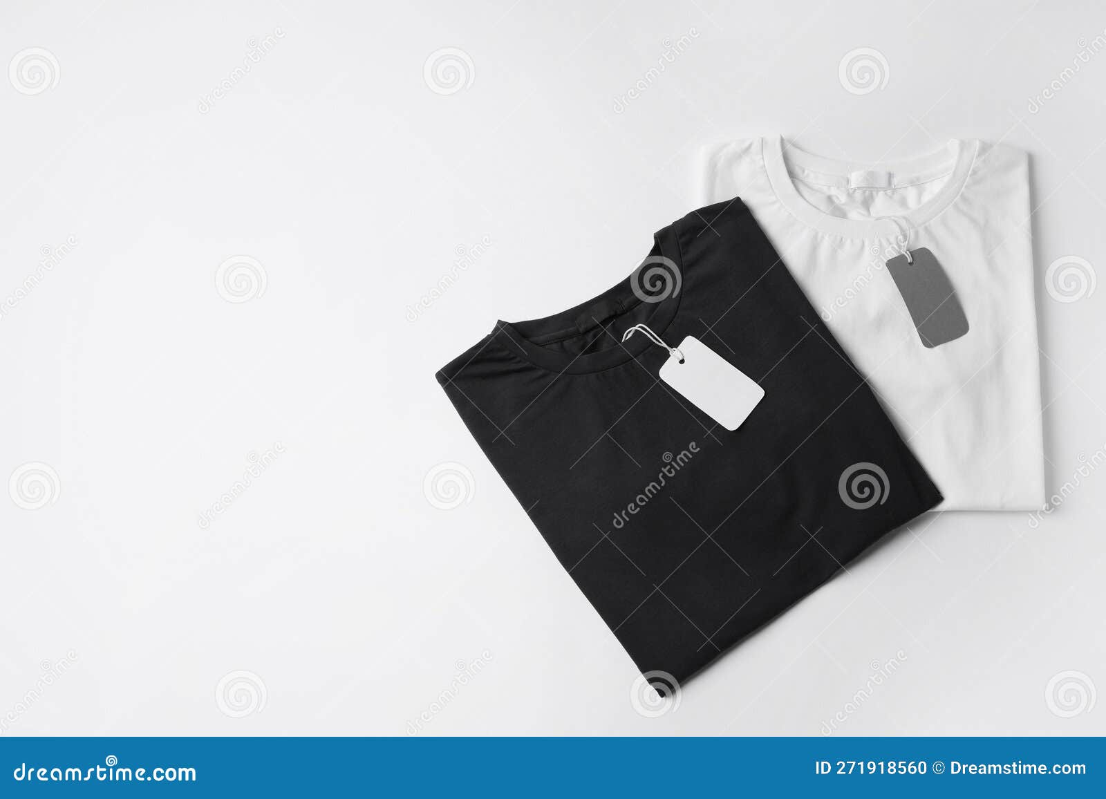 Stylish T-shirts with Labels on White Background, Top View. Space for ...