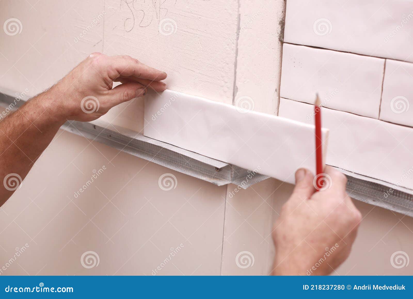 Stylish Trendy White Ceramic Tiles on the Kitchen Wall. Hands in the ...