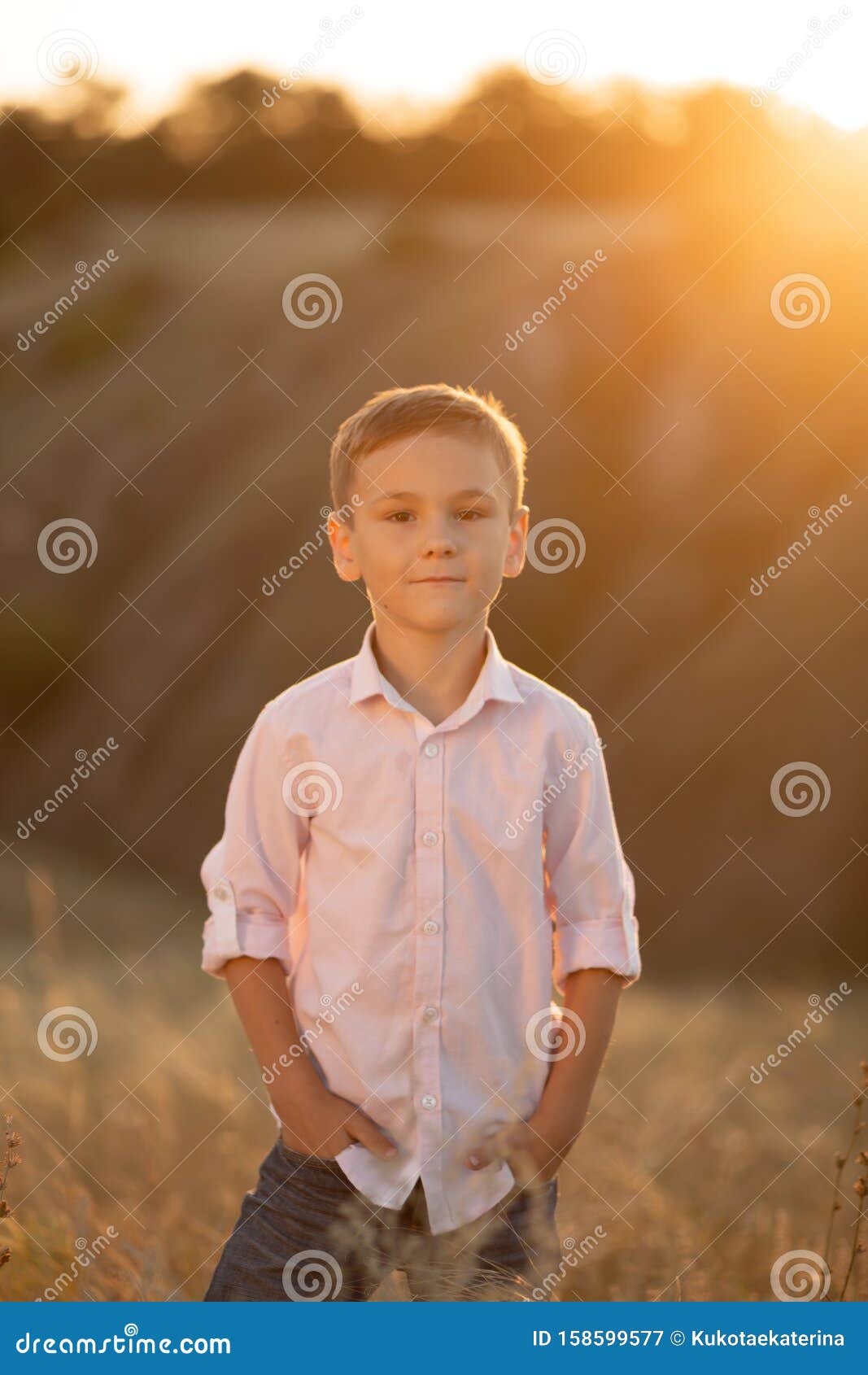 Stylish Young Boy Posing in Field at Sunset Stock Image - Image of ...