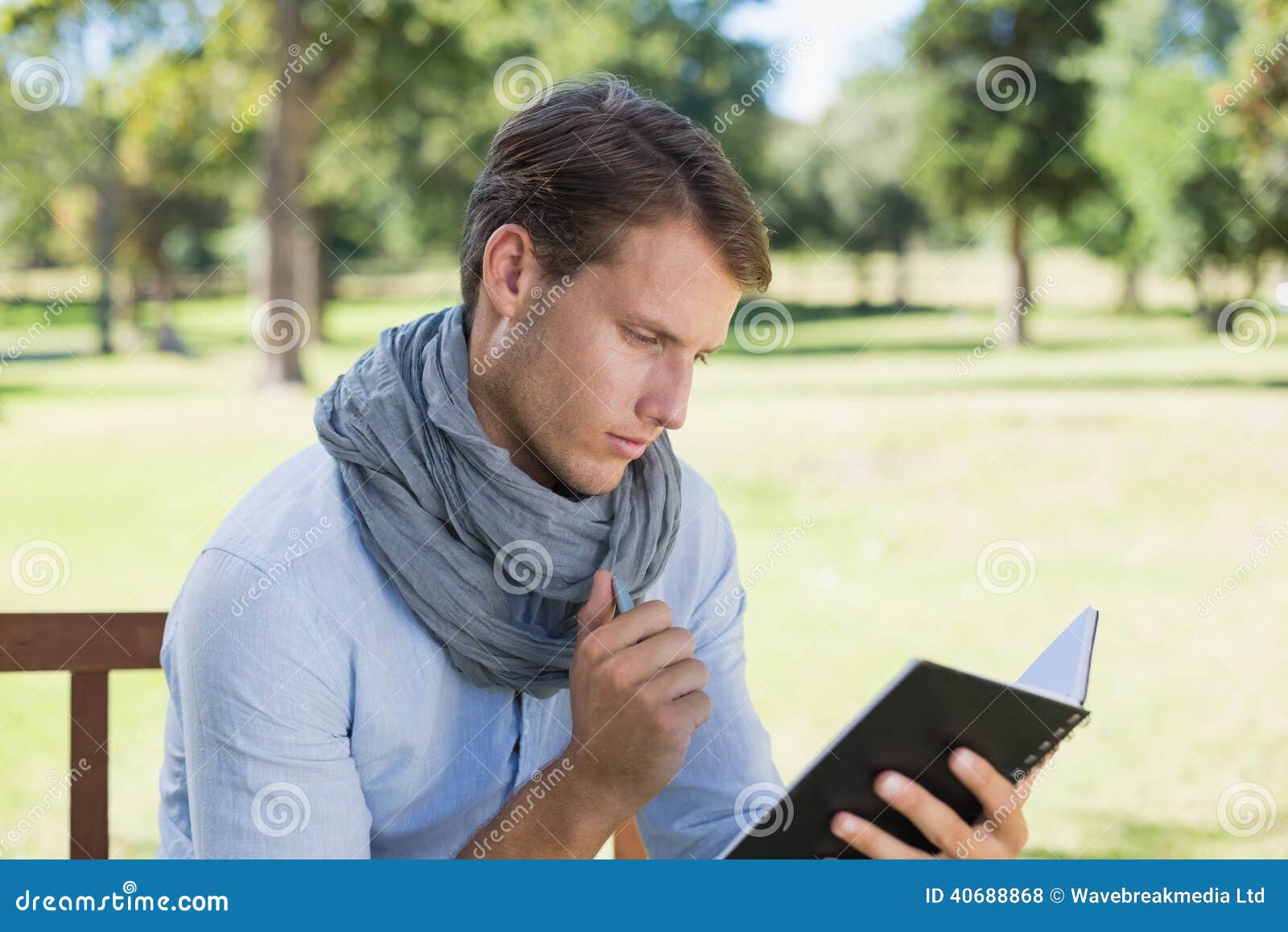 Stylish Young Man Writing in His Notepad Stock Photo - Image of ...