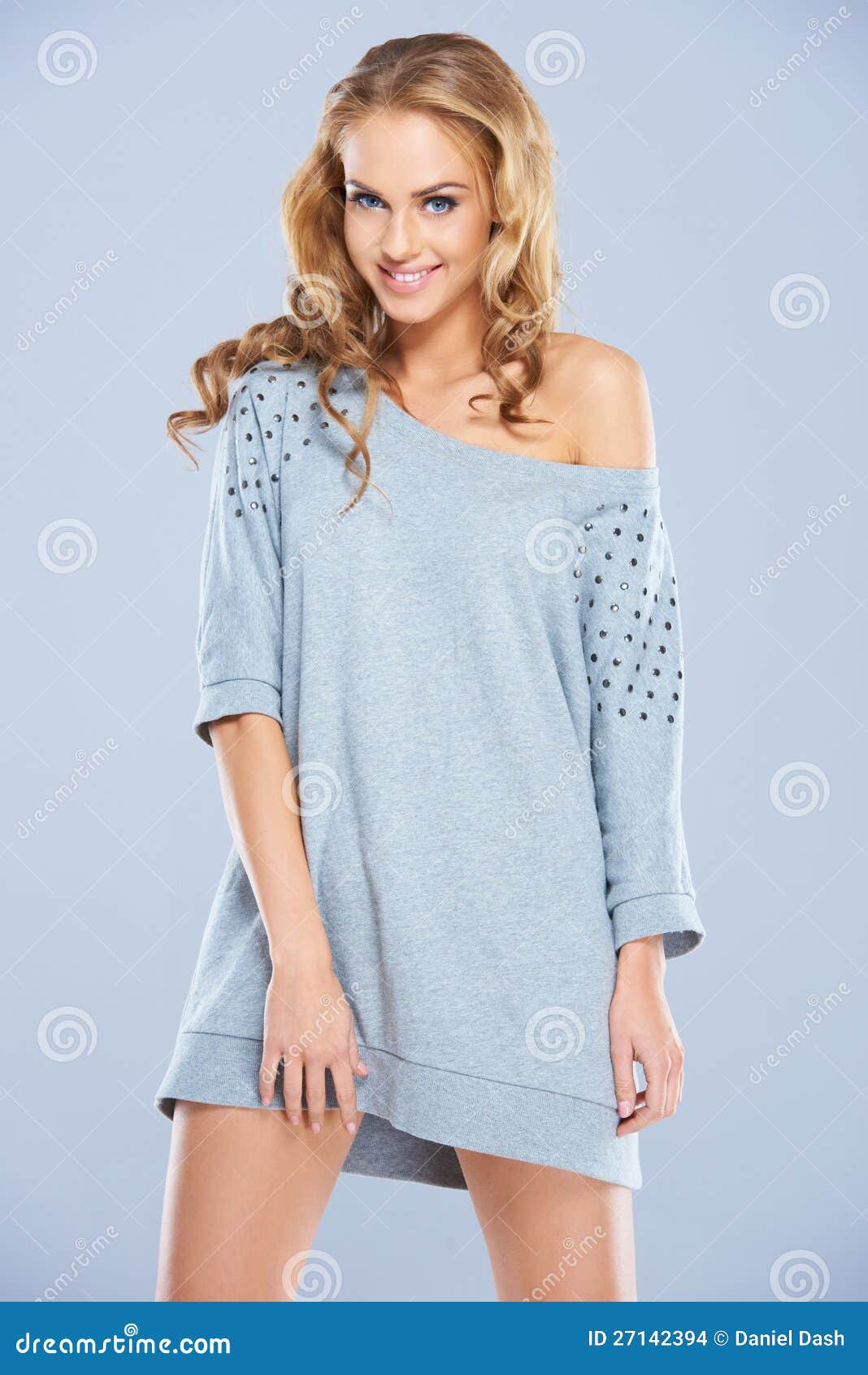 Stylish Young Woman In Ripped Jeans In Front Of City Mall. Royalty-Free ...