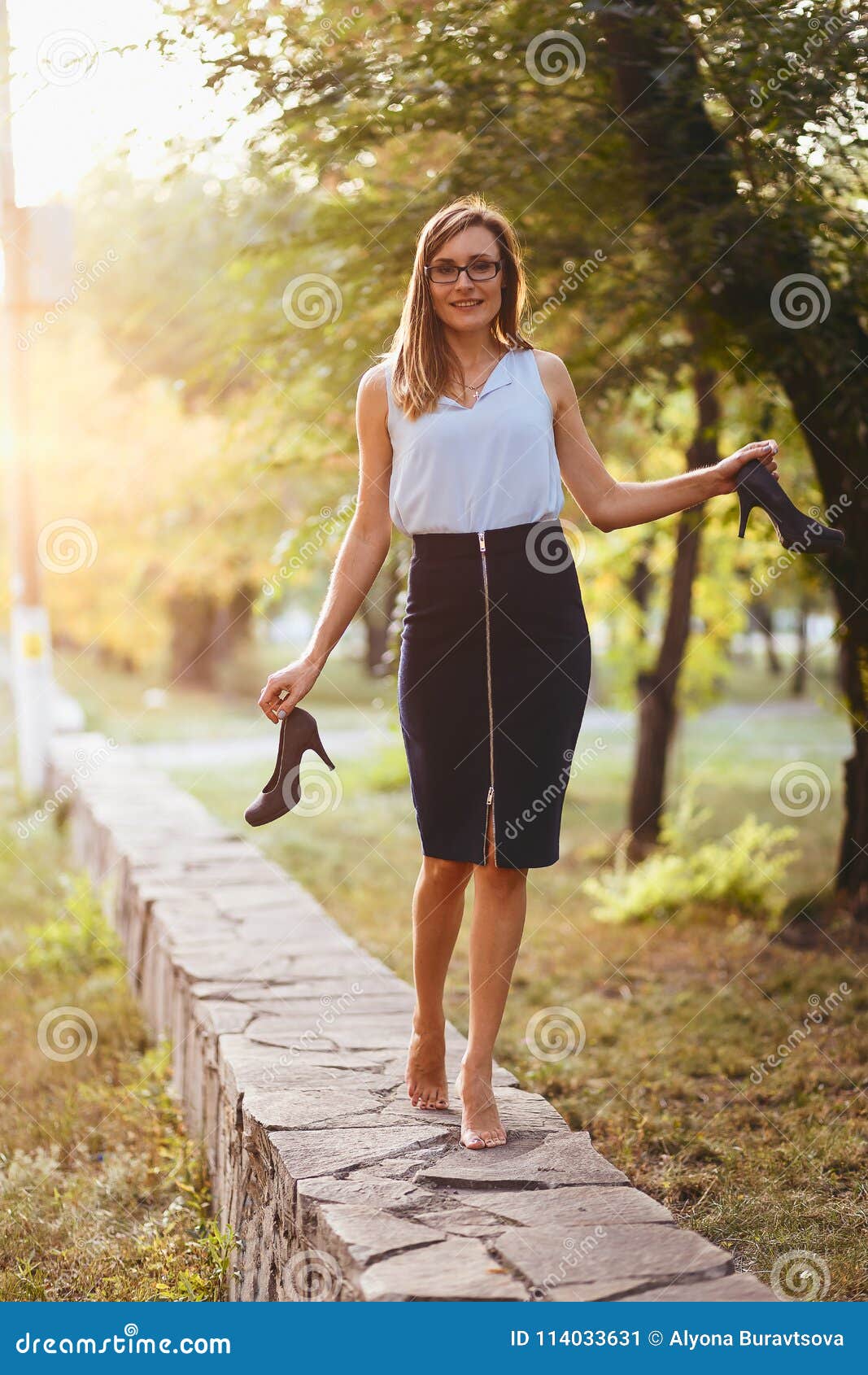 Stylish Young Woman Walking Barefoot and Holding Shoes in Hand Stock ... Stylish Young Woman Walking Barefoot and Holding Shoes in Hand Stock ...