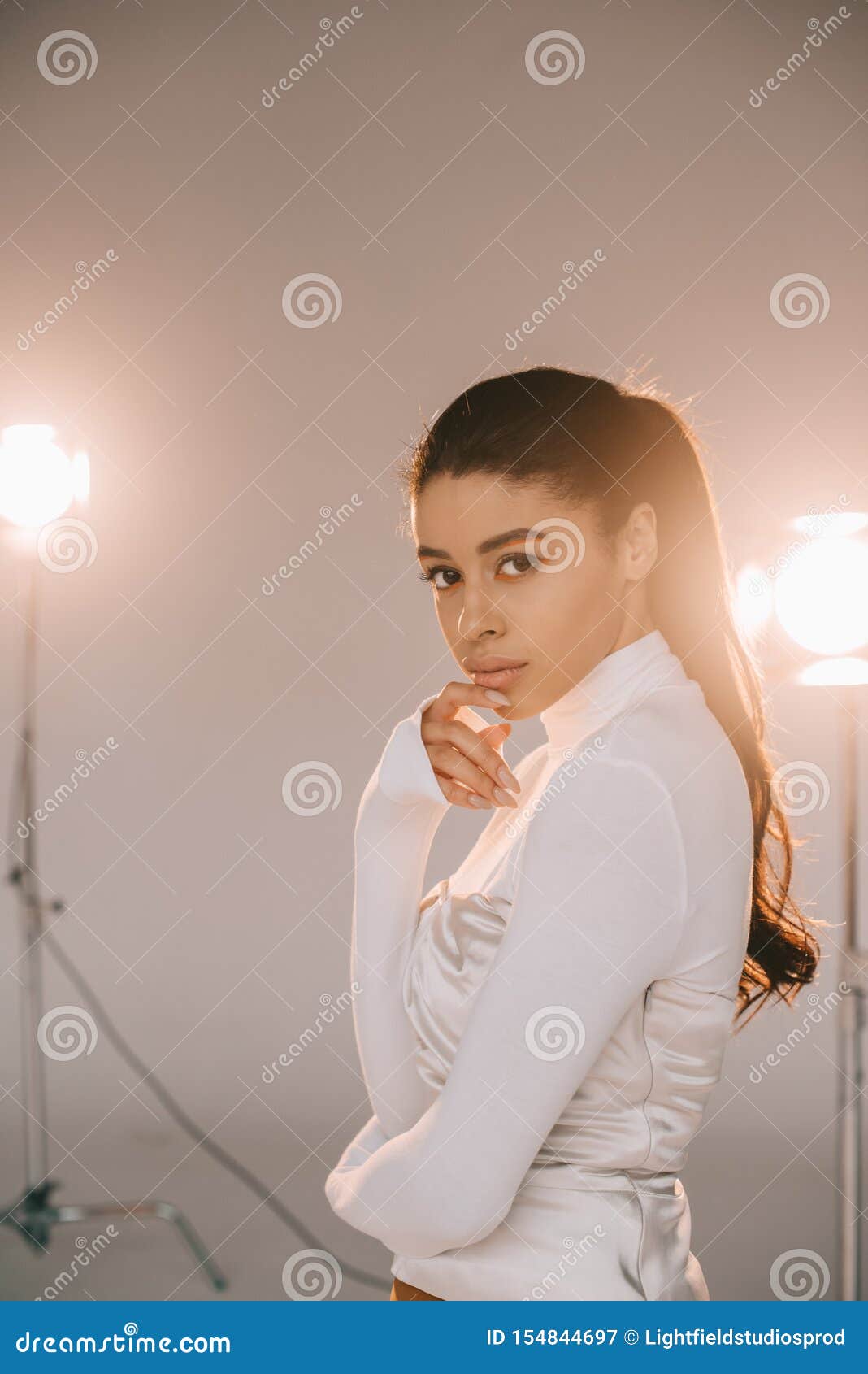 Stylish Young Woman in White Turtle Neck Posing in Studio Stock Image ...