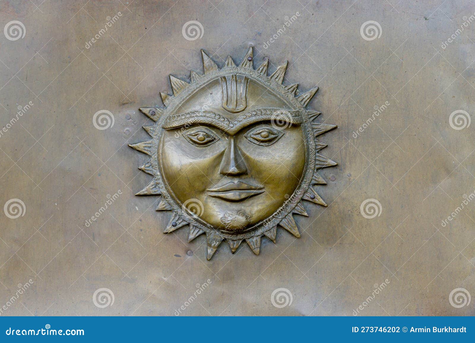 Stylized Bronze Sun with Face Looking Serious from Under Large Eyebrows ...