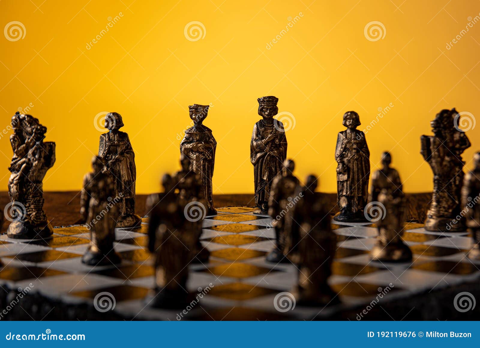 Stylized Chess Pieces on a Board with Orange Background and Selective ...