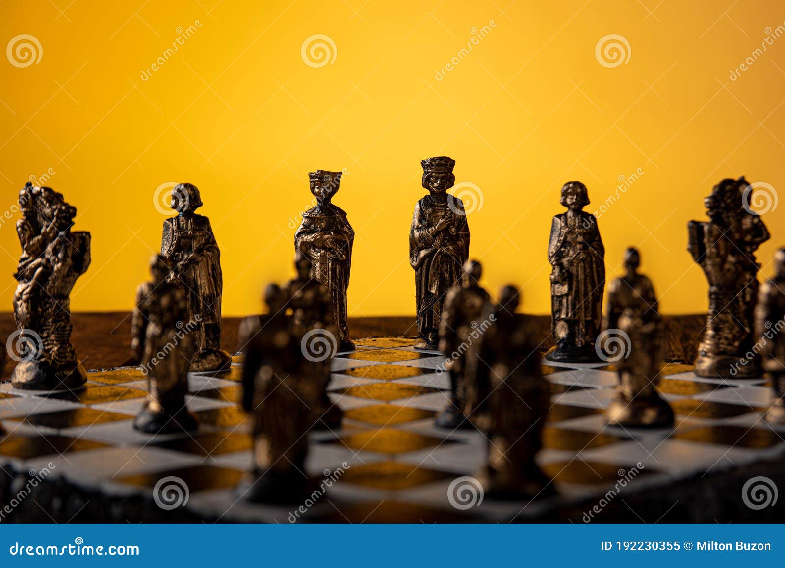 Stylized Chess Pieces on a Board with Orange Background and Selective ...