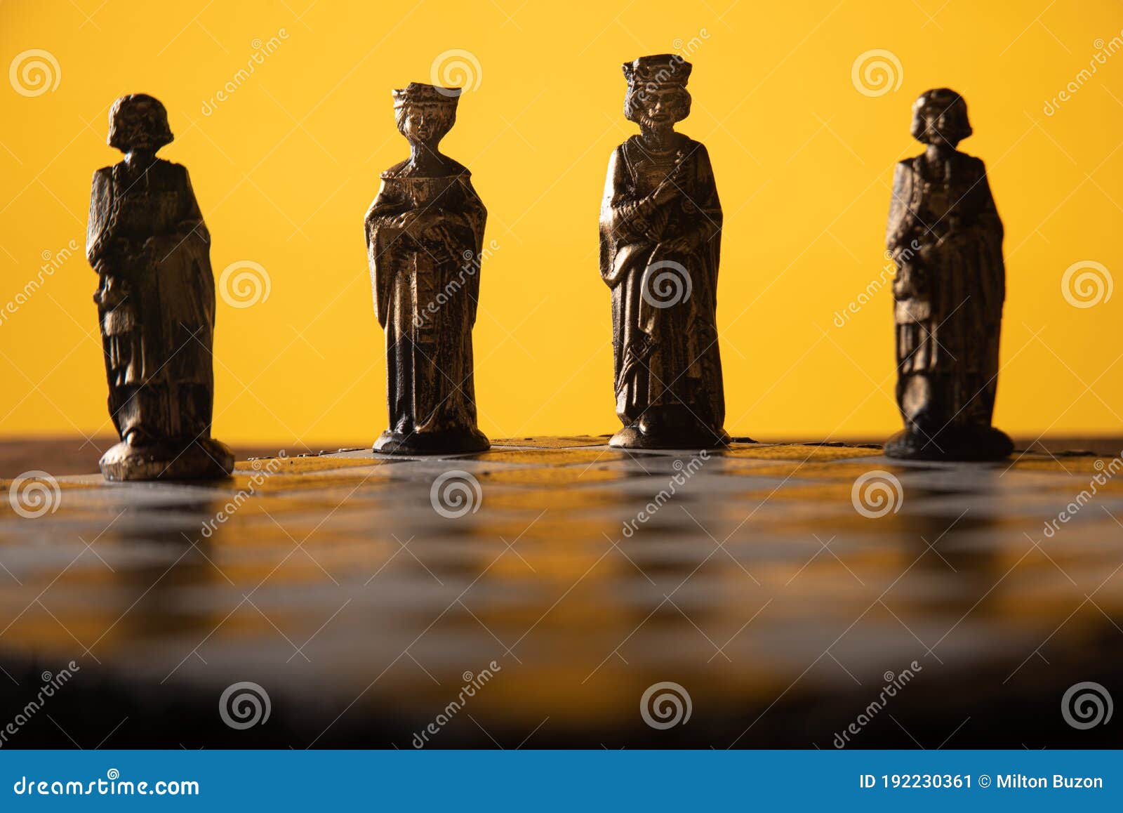Stylized Chess Pieces on a Board with Orange Background and Selective ...