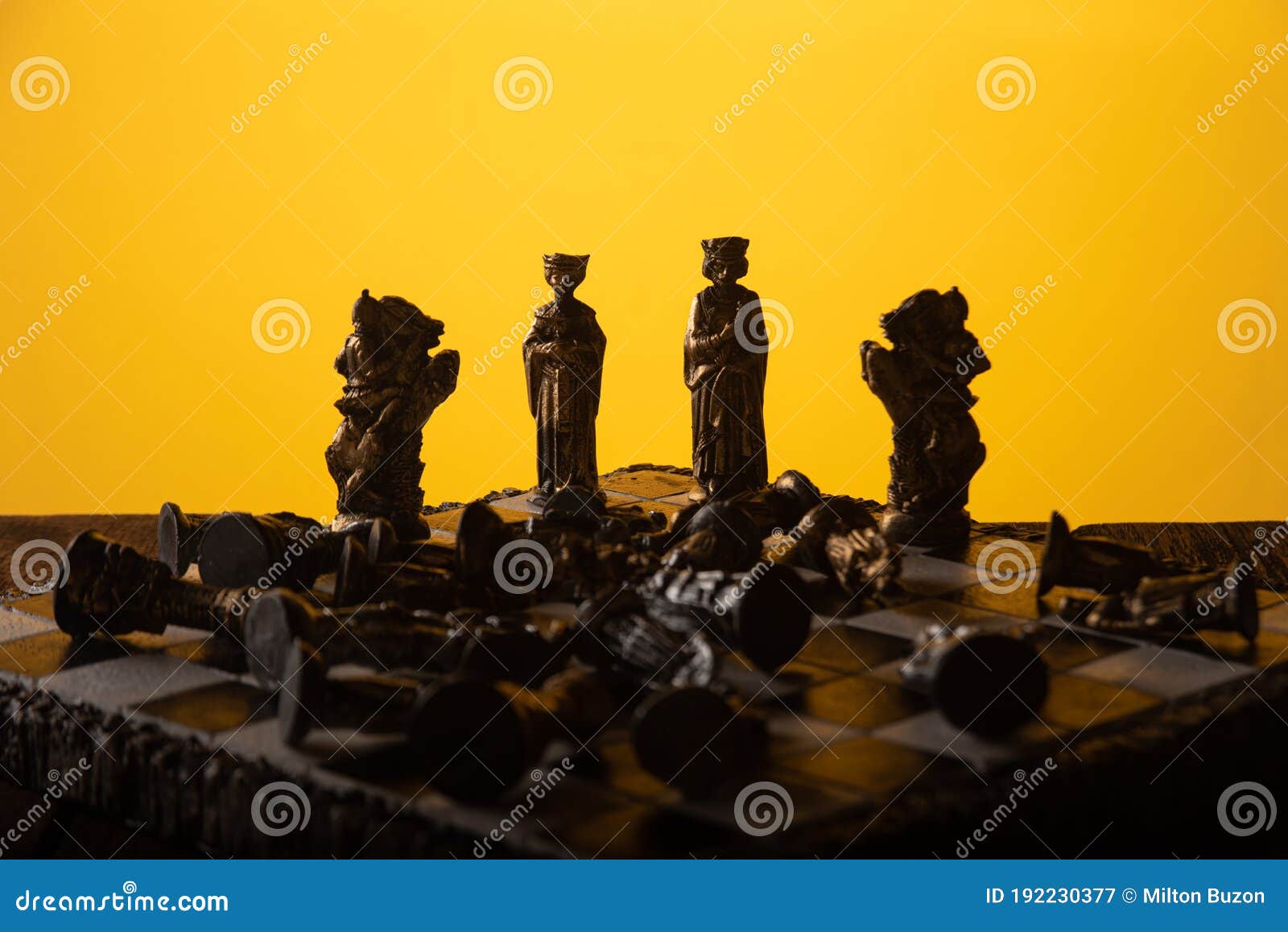 Stylized Chess Pieces on a Board with Orange Background and Selective ...