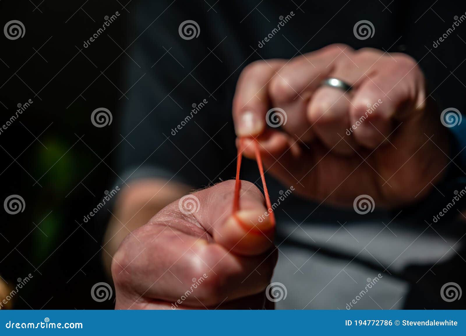 Subjective Focus on Rubber Band Pulled Taunt Being Aimed at the Camera ...