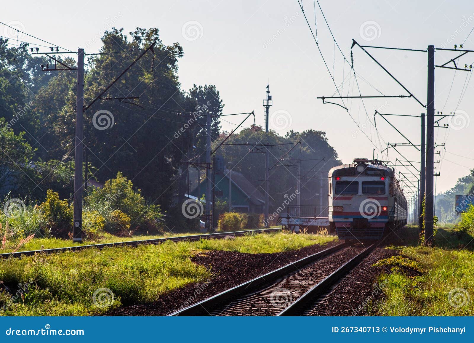 Suburban Passenger Trains are Moving Along the Railroad. Editorial ...