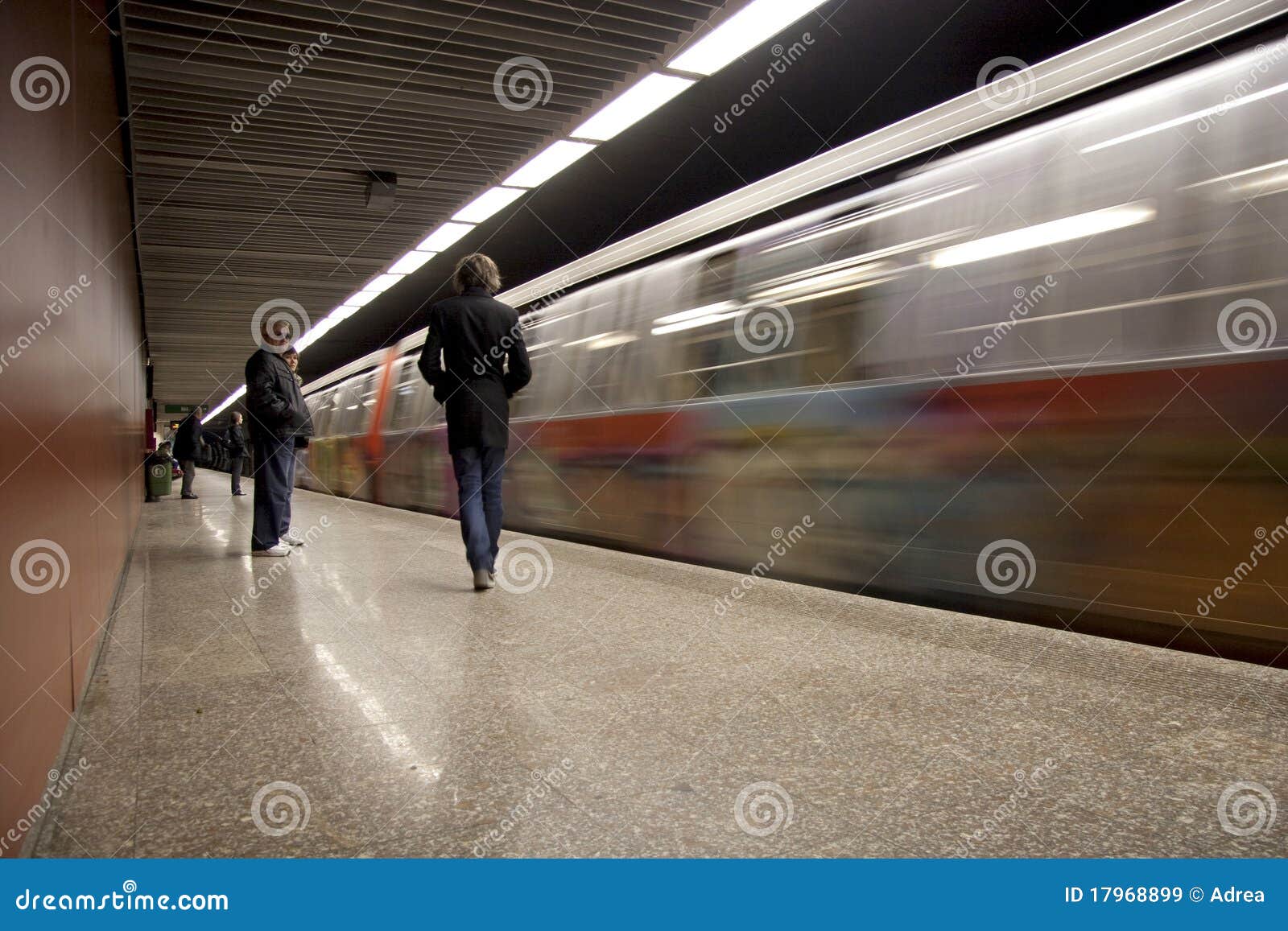 Subway Train Leaving the Station and People Waiting for the Next One ...