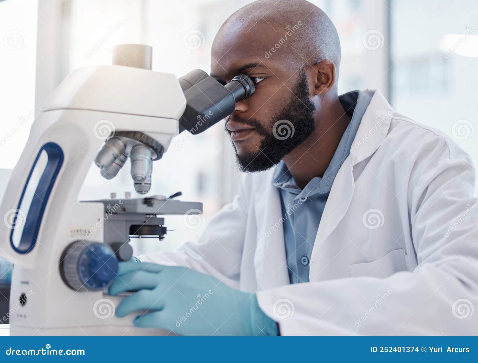 Success is a Science. a Young Scientist Using a Microscope in a ...