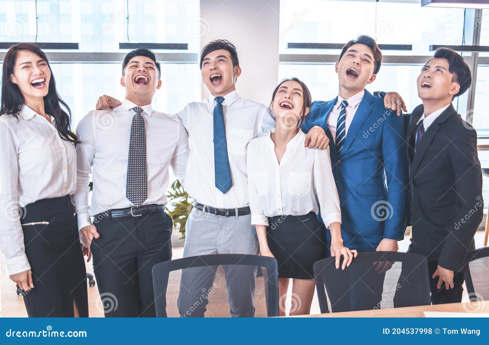 Successful Business Team Laughing and Singing Together Stock Photo ...